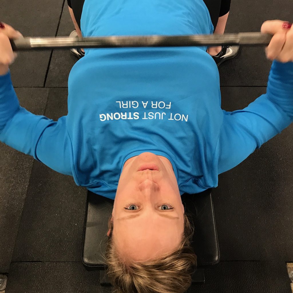 Beautiful Woman Doing Bench Press - Larson Sports and Orthopaedics