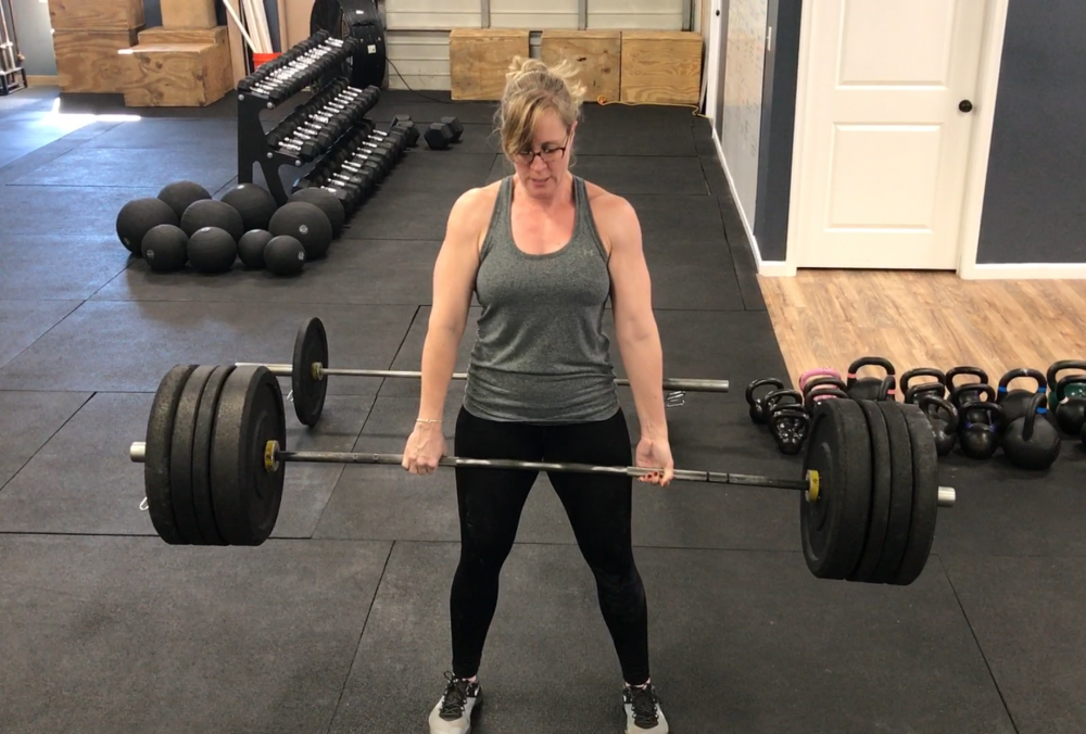 Kristen Performs a deadlift - Larson Sports and Orthopaedics